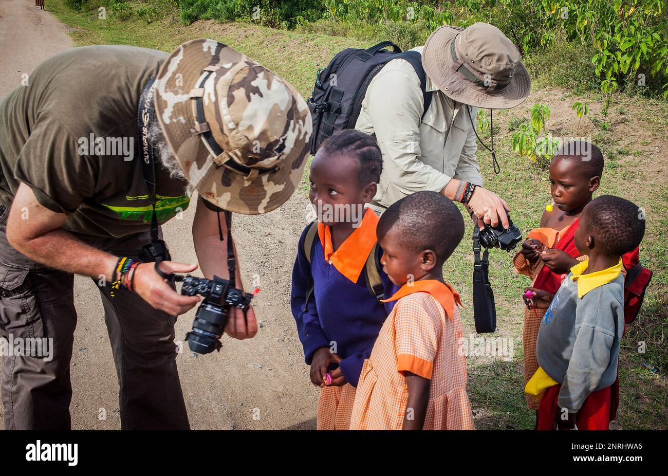 photographers showing pictures to children, near the fishing village of ...
