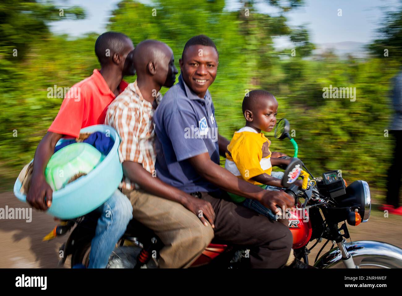 Men and boy riding bike, in the fishing village of Kolunga, Rusinga ...