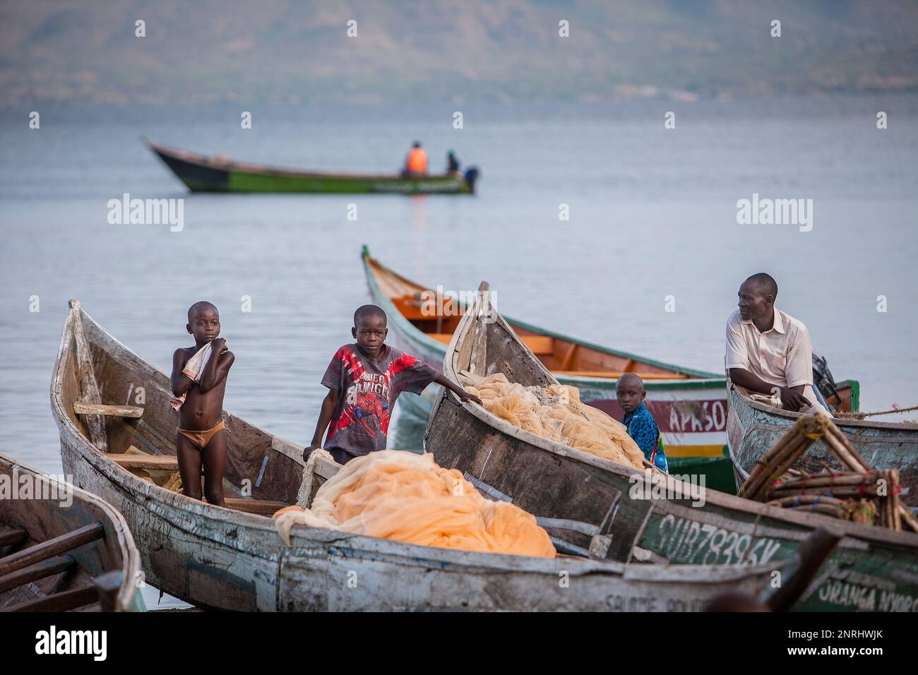 Children and men in the port, the fishing village of Kolunga, Rusinga ...