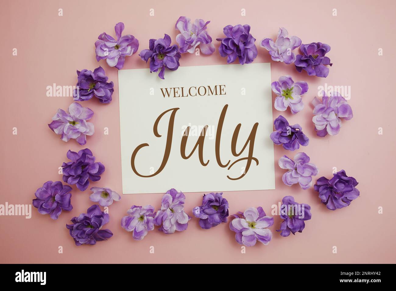 Welcome July card typography text with flower bouquet on pink ...