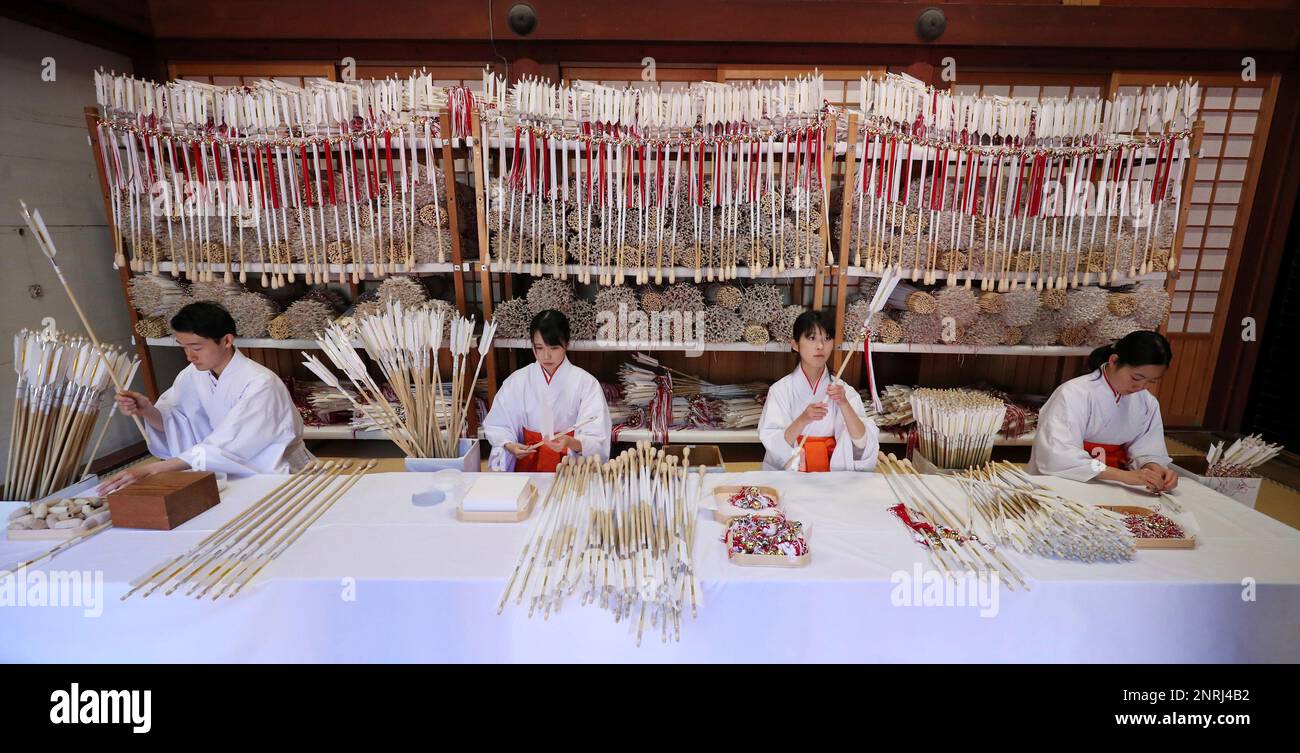 Miko shrine maidens are busy making hamaya, or evil-repelling arrows at ...
