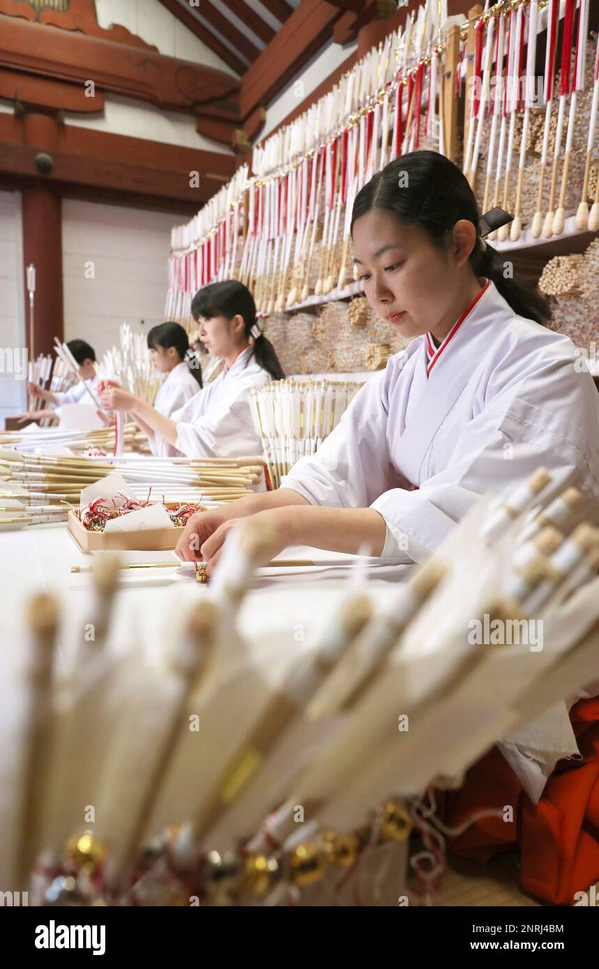 Miko shrine maidens are busy making hamaya, or evil-repelling arrows at ...
