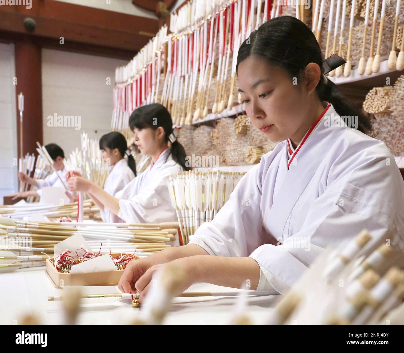 Miko shrine maidens are busy making hamaya, or evil-repelling arrows at ...