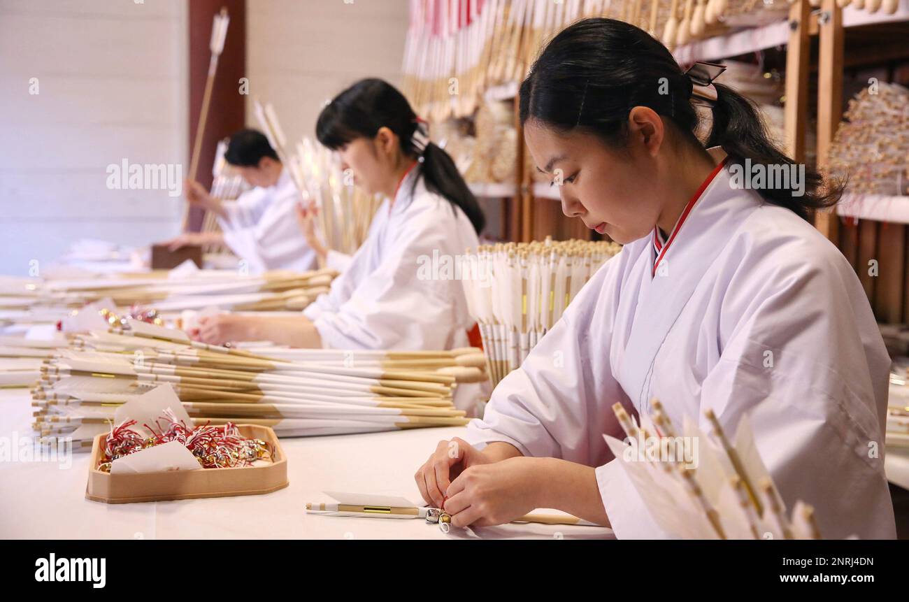 Miko shrine maidens are busy making hamaya, or evil-repelling arrows at ...