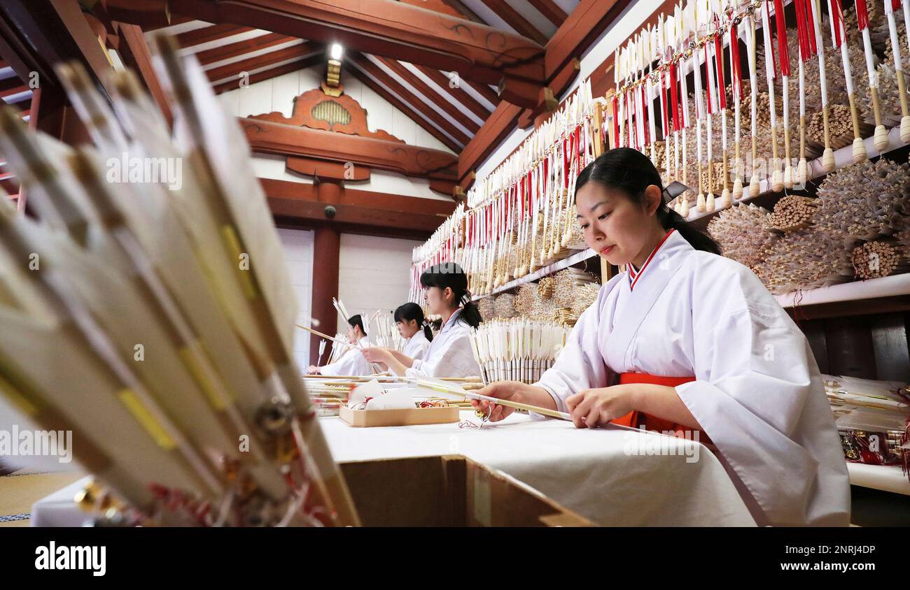 Miko shrine maidens are busy making hamaya, or evil-repelling arrows at ...