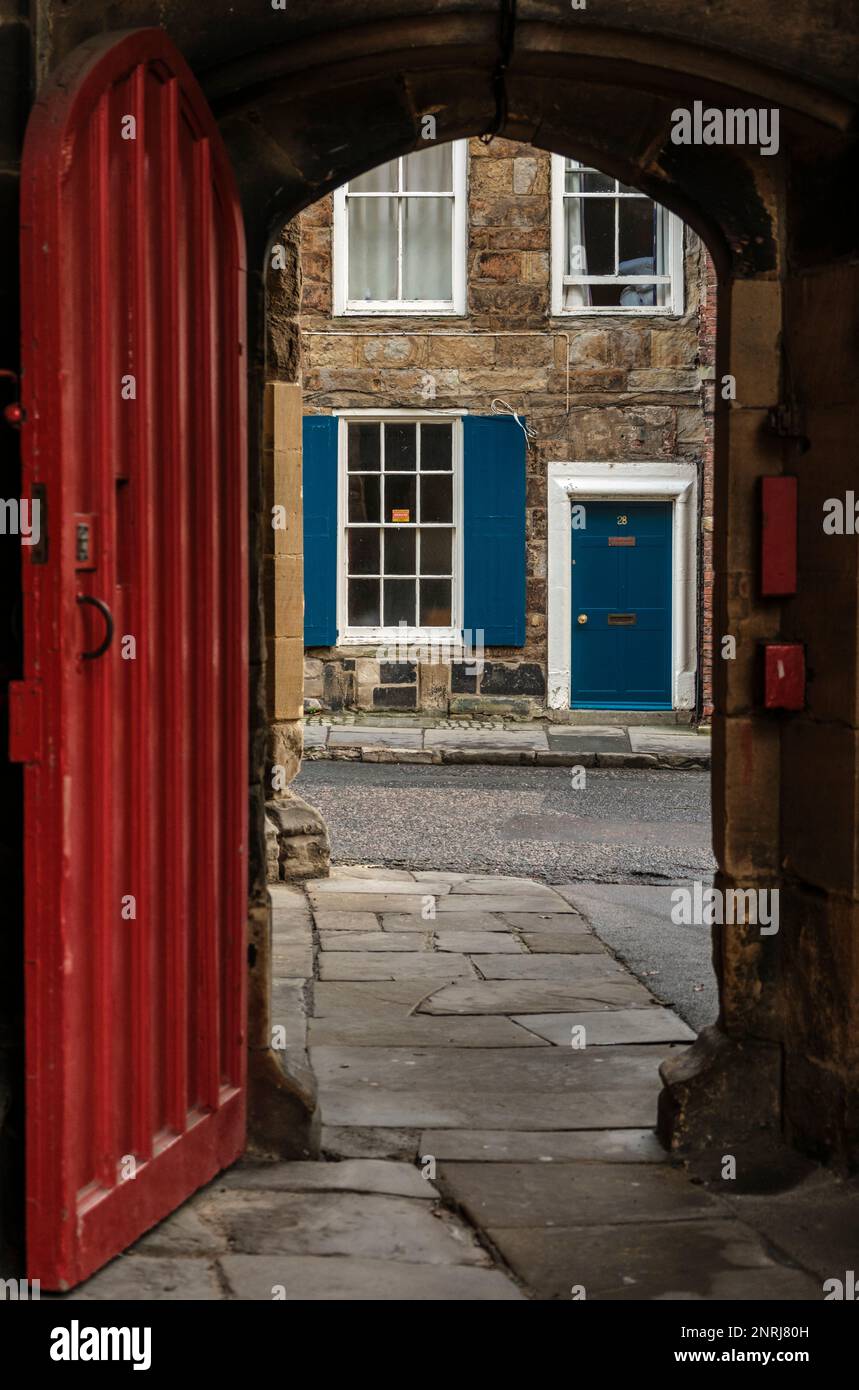 View through red gate to blue door in Durham, England Stock Photo - Alamy