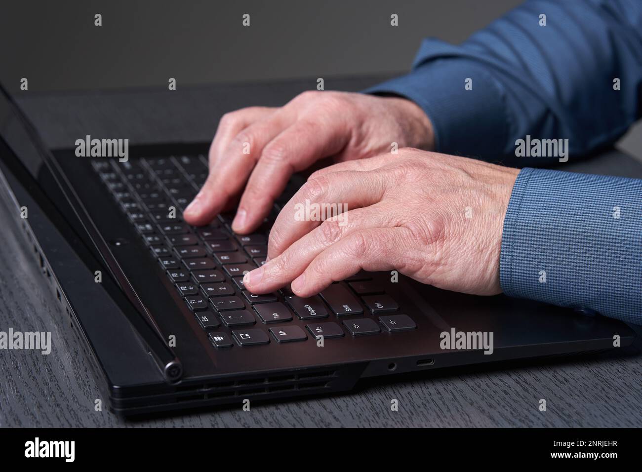 Hands of a mature businessman typing fast on the keyboard of his laptop Stock Photo - Alamy