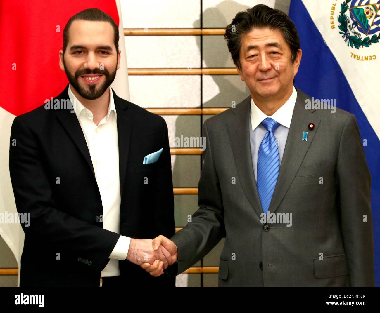 Japan's Prime Minister Shinzo Abe, right, shakes hands with El Salvador ...