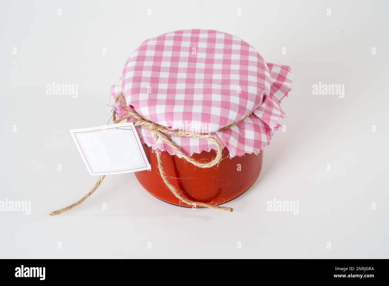 Canned homemade tomato paste jar with empty label isolated on white ...