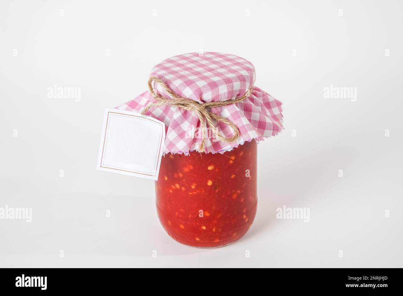 Canned homemade tomato paste jar with empty label isolated on white ...