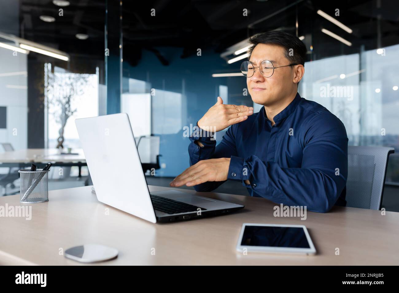 Angry Asian boss talking to colleagues on video call, man dissatisfied ...