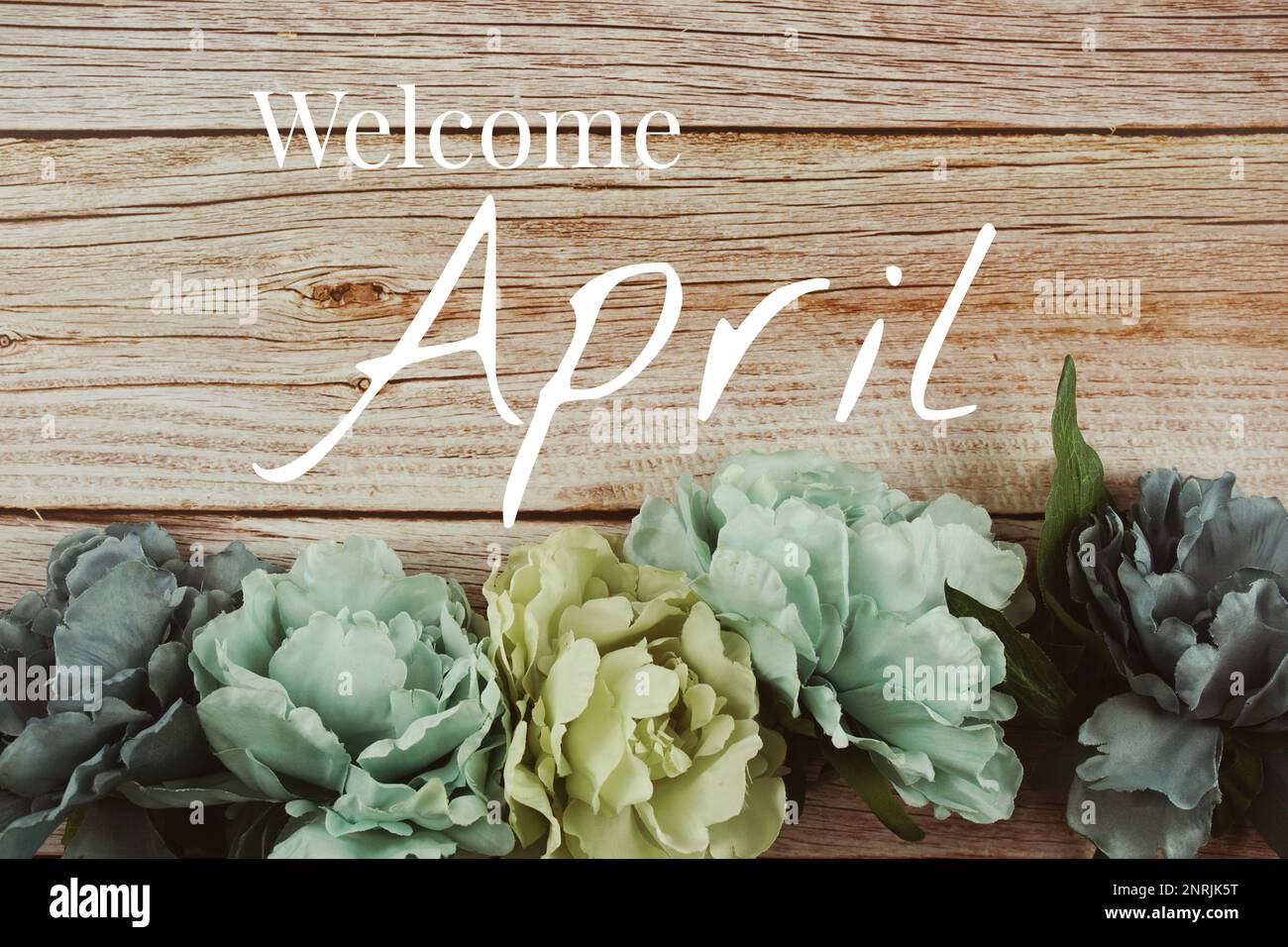 Welcome April typography text with blue flowers bouquet on wooden ...