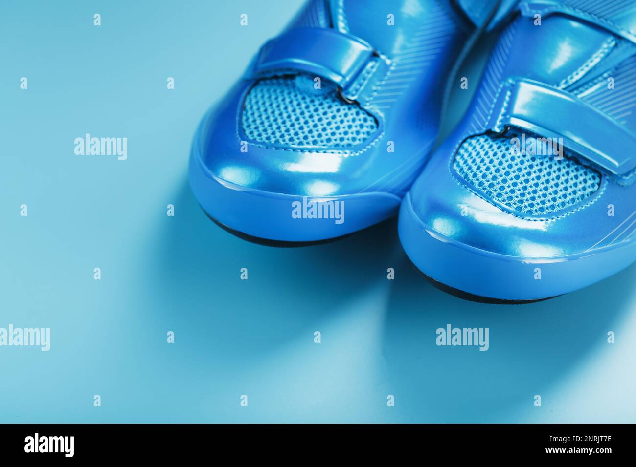 Blue Shiny Bicycle Shoes for Road Bike on Blue Background Stock Photo ...