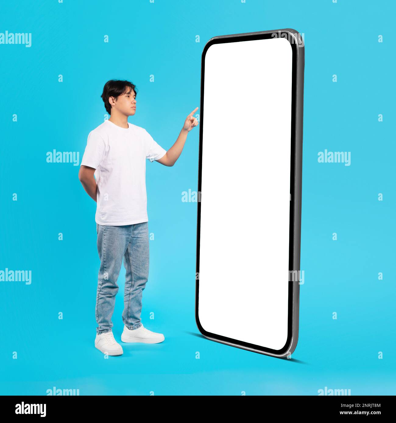 Japanese Teenager Guy Touching Huge Mobile Phone Screen, Blue ...