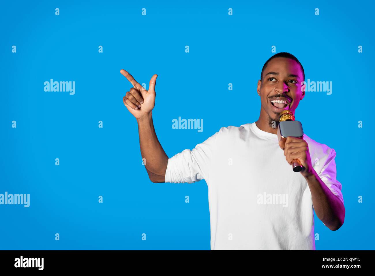 Cheerful handsome young black man journalist holding microphone Stock ...