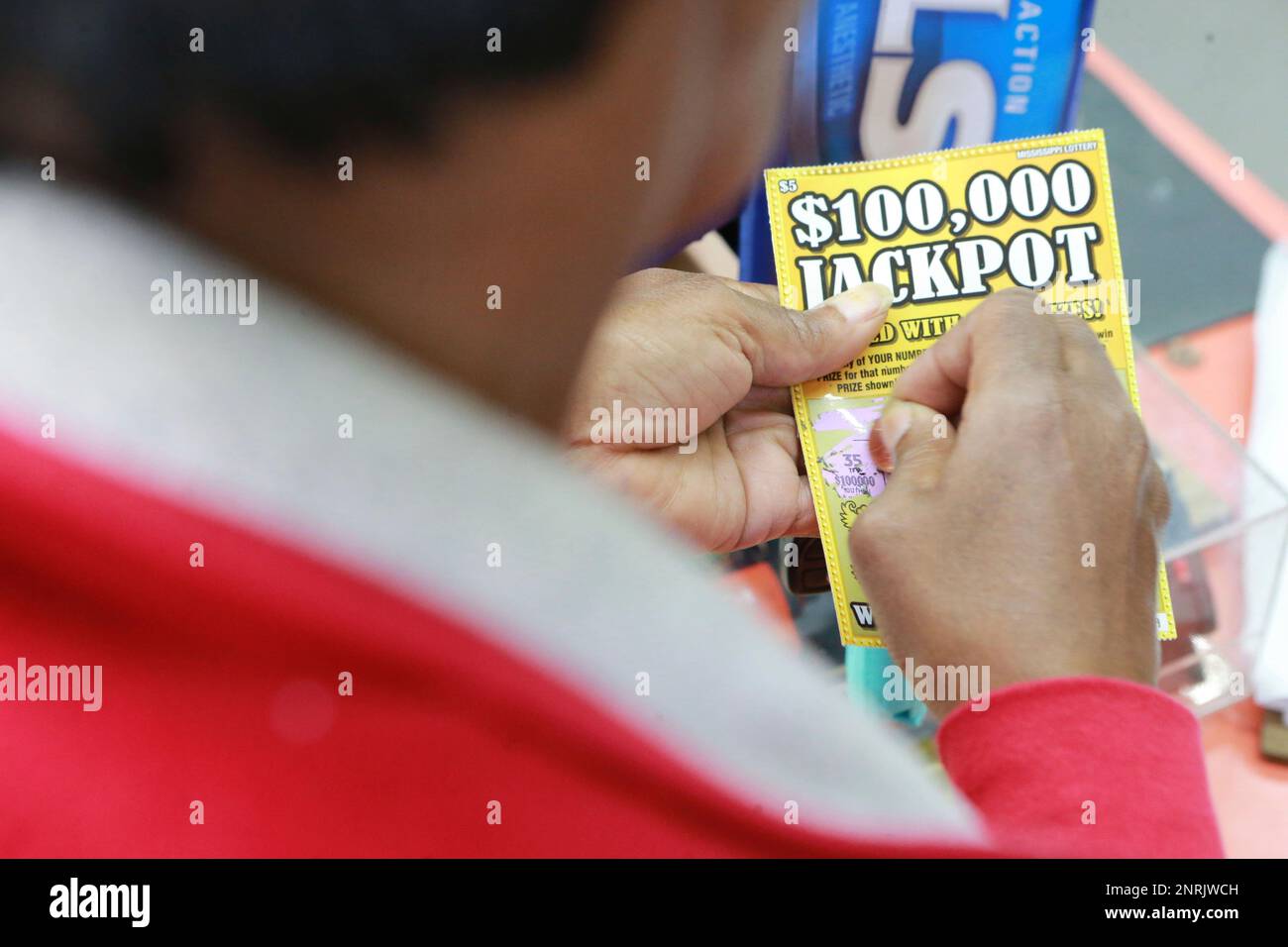 A Lee County resident takes a moment and scratches off her first ...