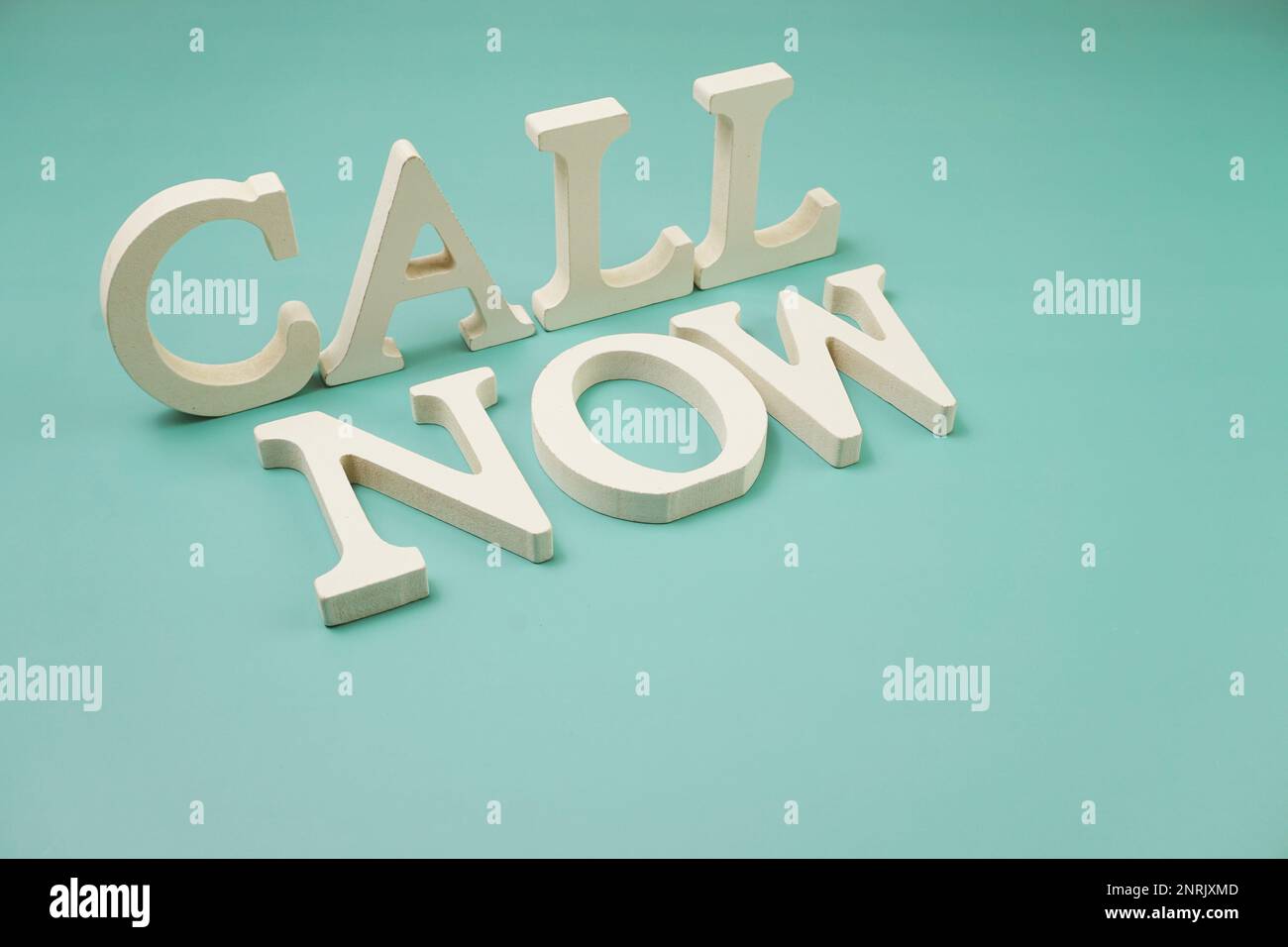 Call Now Word alphabet letters on blue background Stock Photo - Alamy