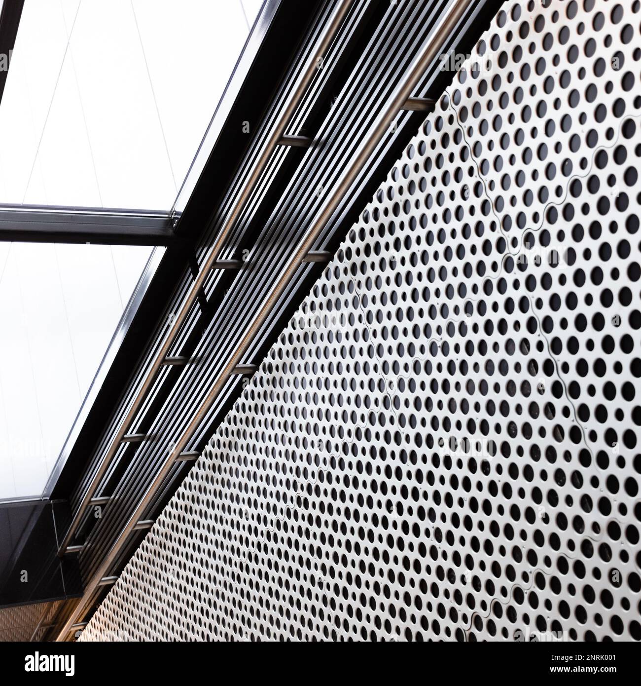 metal mesh lattice and overhead light in underground passage of metro ...