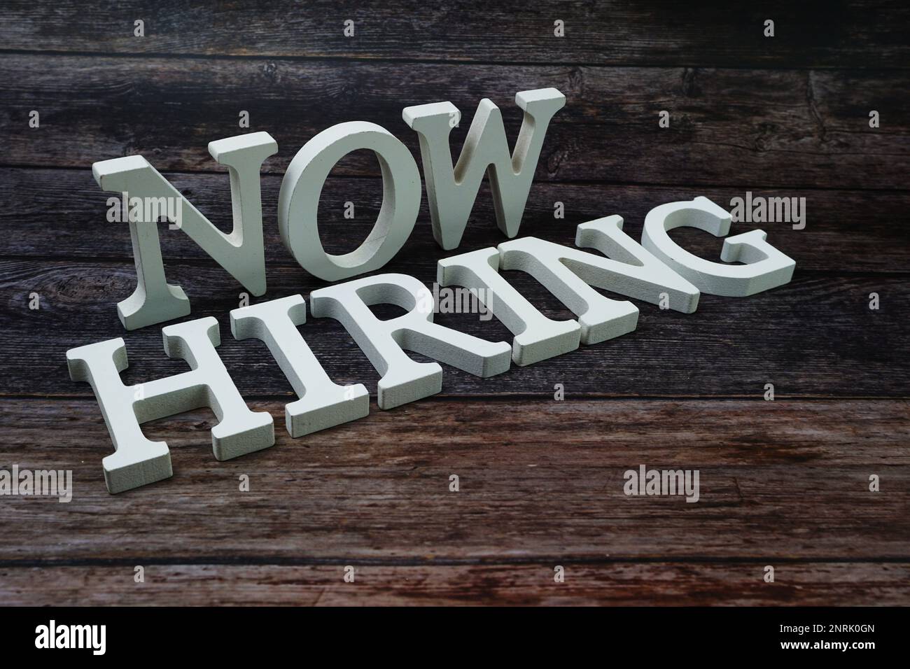 Now Hiring Word alphabet letters on wooden background Stock Photo - Alamy