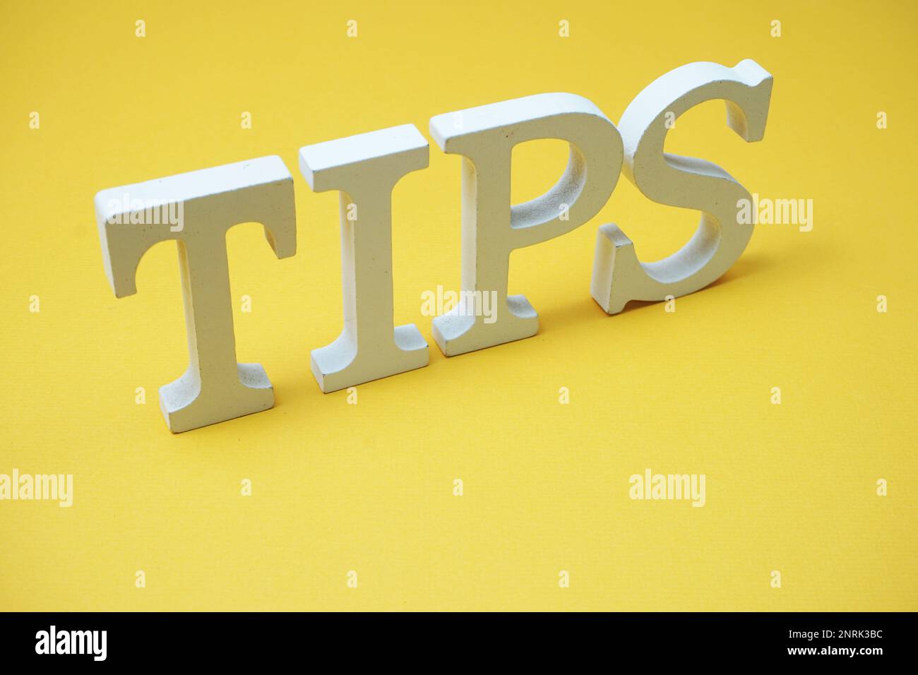 Tips alphabet letters on yellow background Stock Photo - Alamy