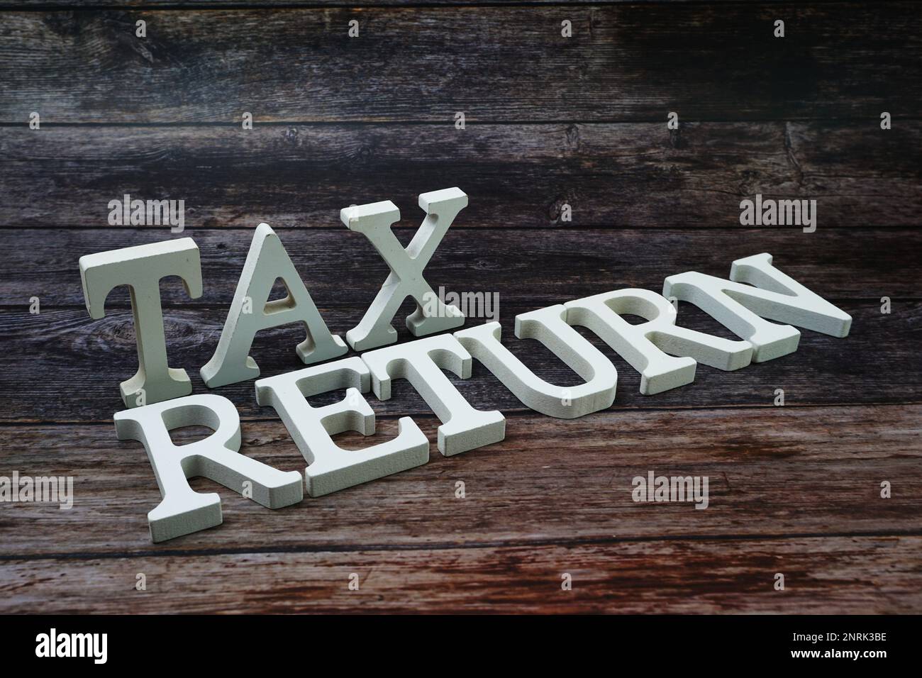Tax Return Word alphabet letters on wooden background Stock Photo - Alamy