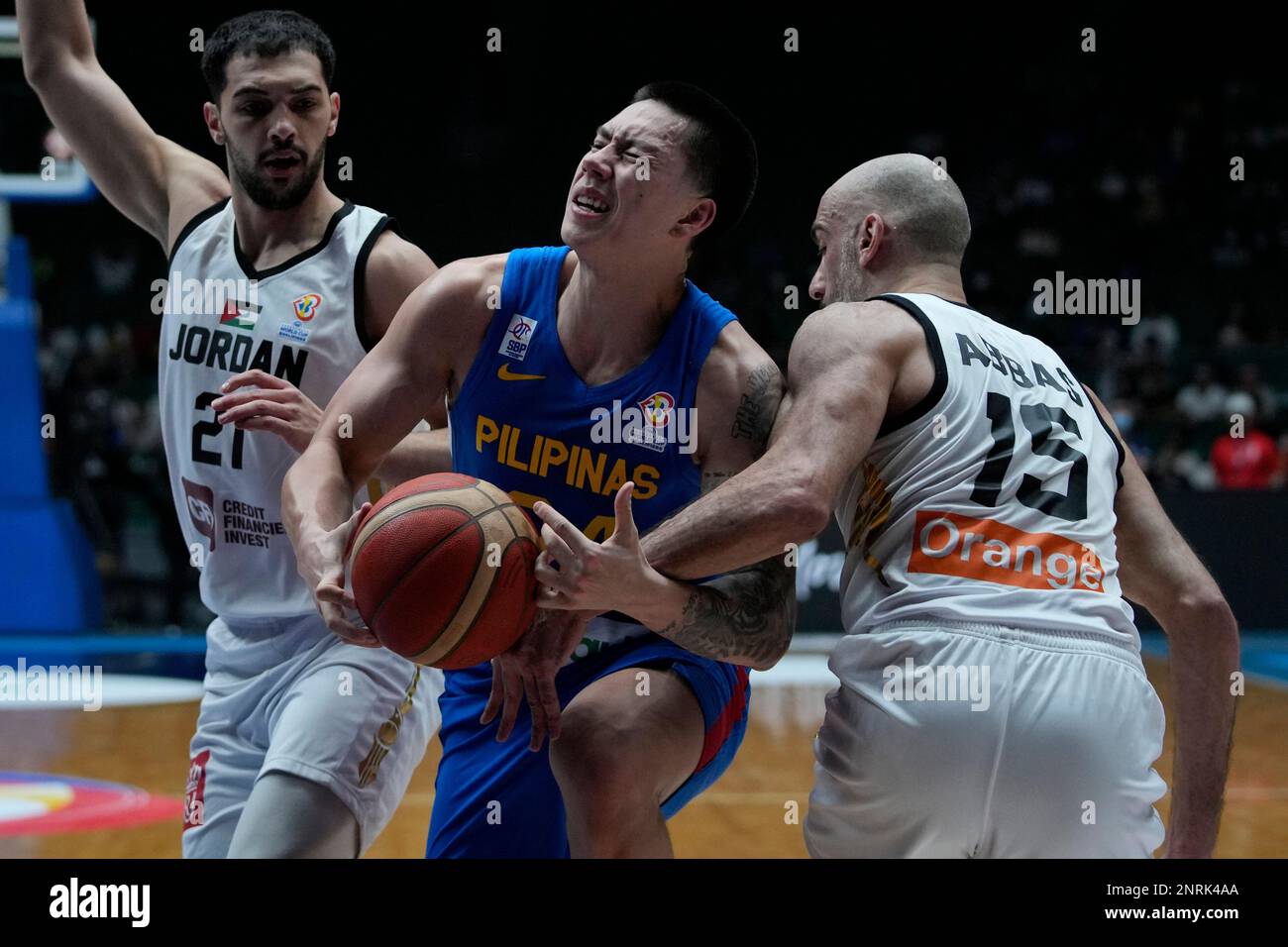 Philippines' Dwight Ramos, center, is fouled by Jordan's Zaid Abbaas ...