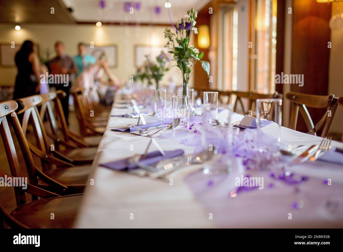 Elegant table setup in purple pastels for a restaurant wedding, indoors ...