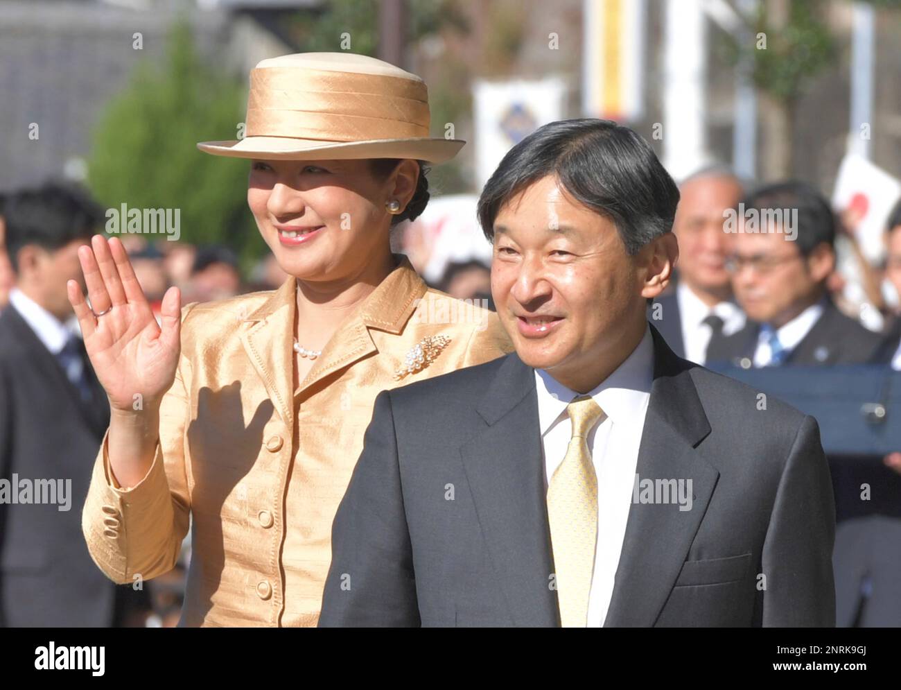 Japan's Emperor Naruhito and Empress Masako wave their hands as they ...
