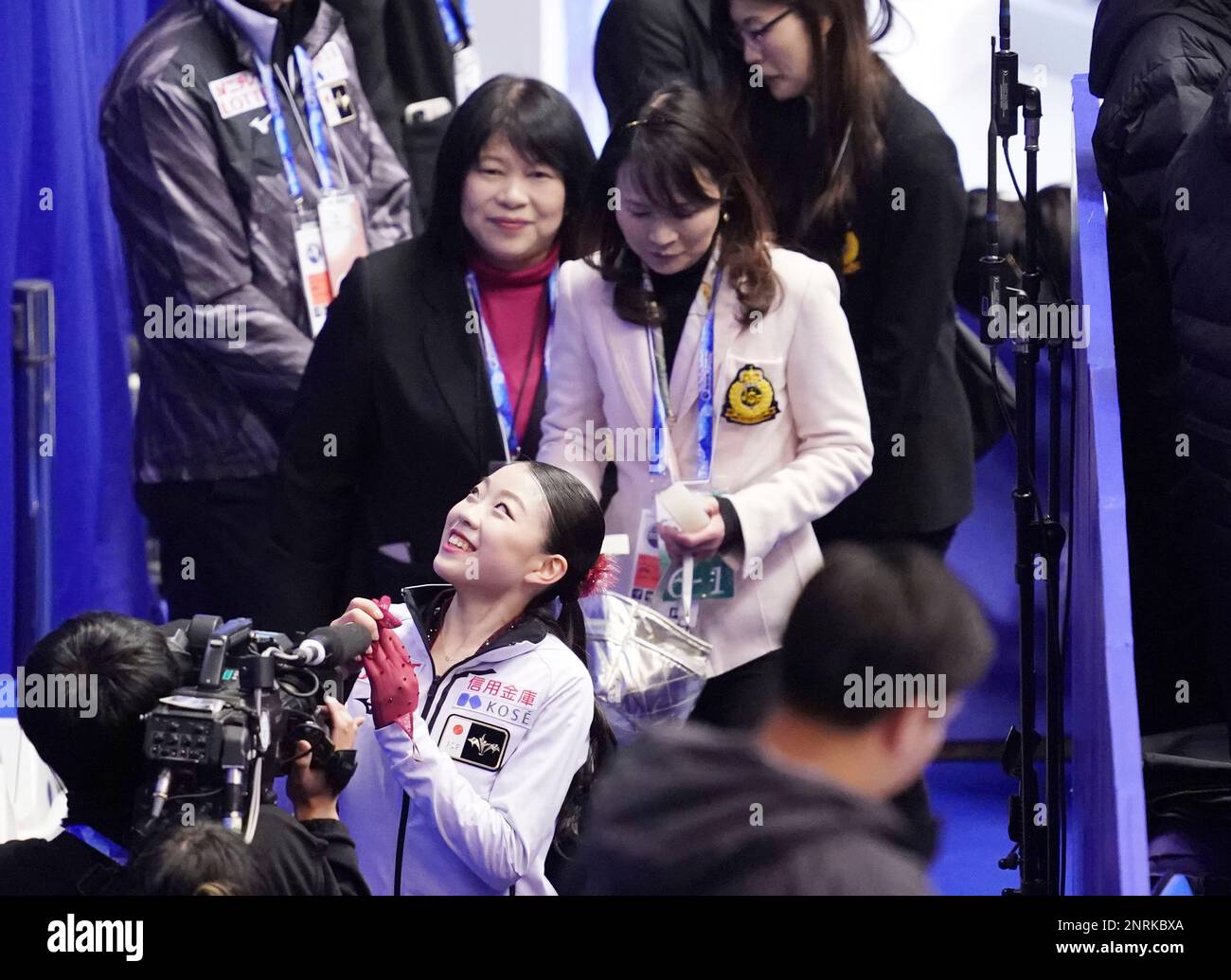 Japanese figure skating coach Mie Hamada (rear R) walks with Rika Kihir ...