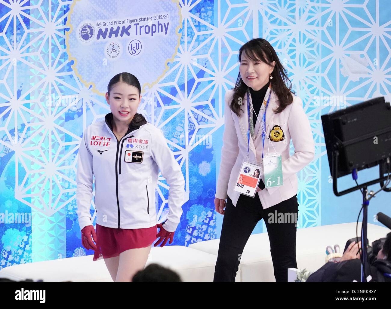 Japanese figure skating coach Mie Hamada (R) walks with Rika Kihir ...