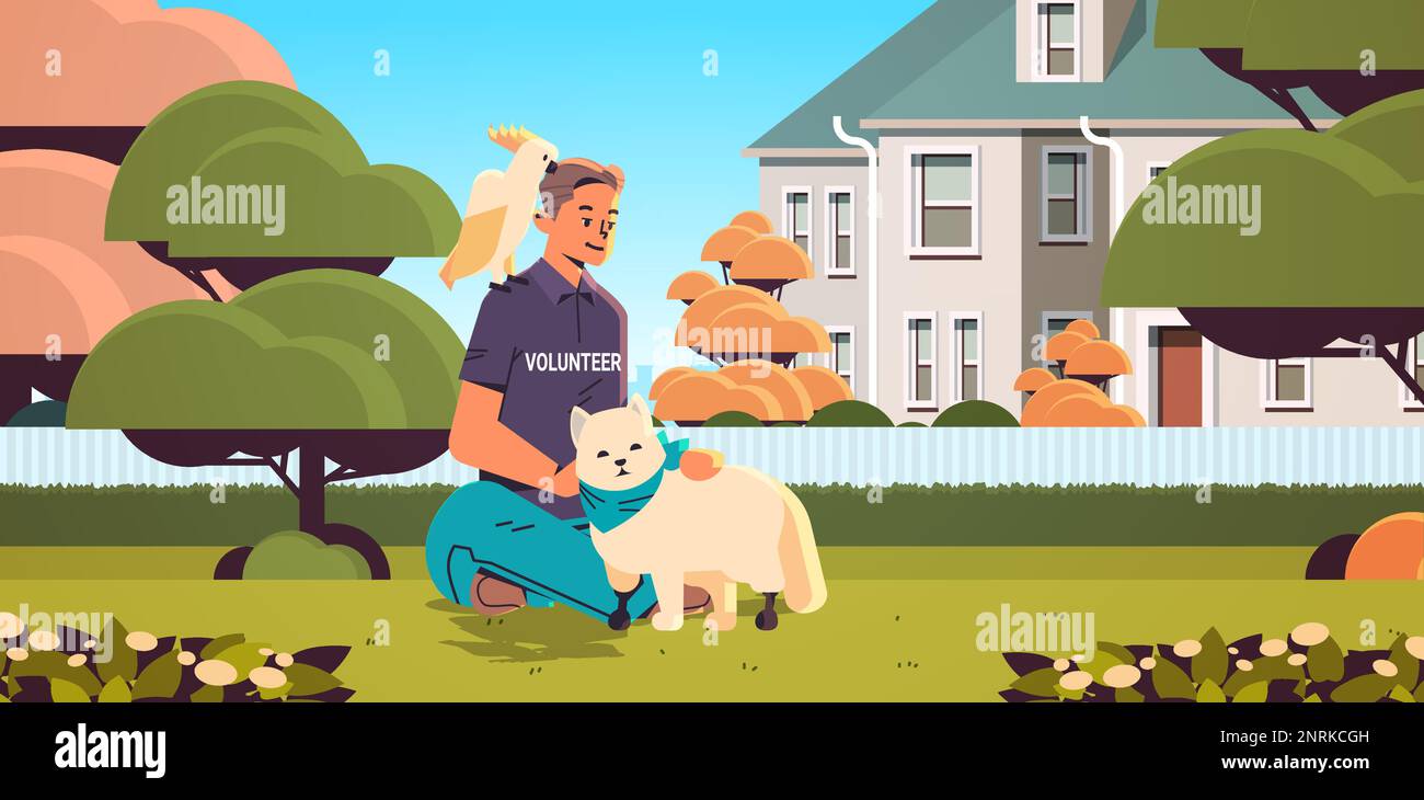 young man volunteer with parrot and cat animals walking outdoor ...