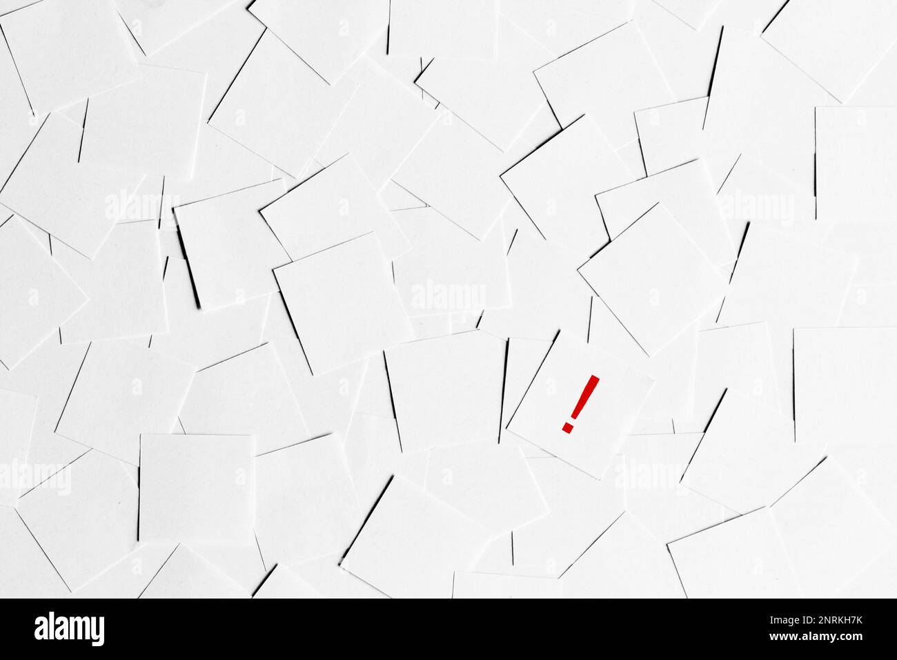 Pile of blank pieces of paper with red exclamation mark in the middle ...