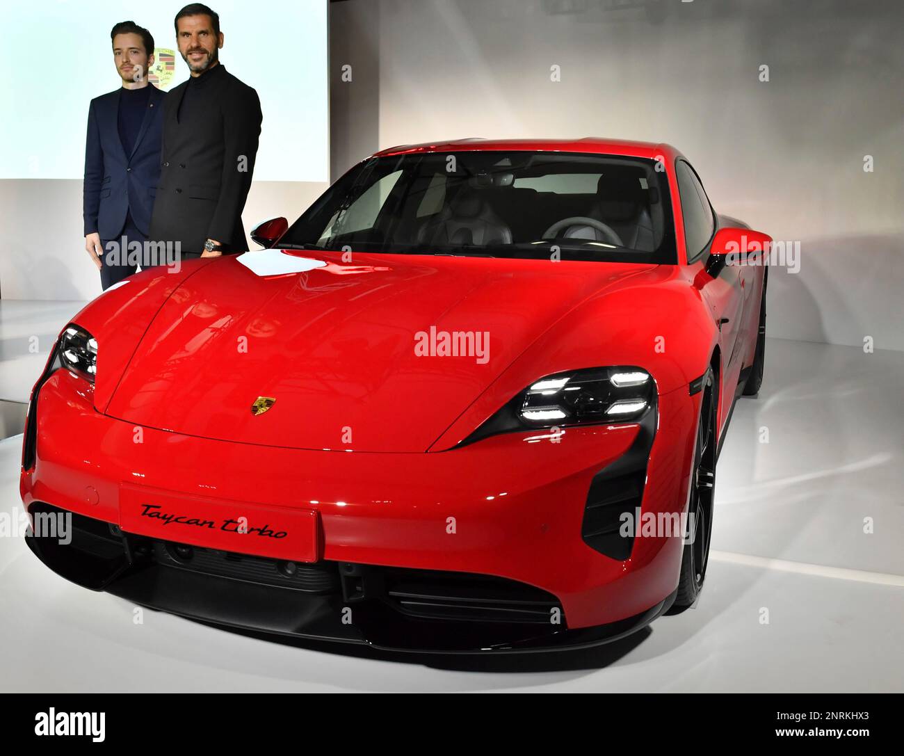 Porsche Japan President MICHAEL-KIRSCH (R) unveils Porsche's first all ...