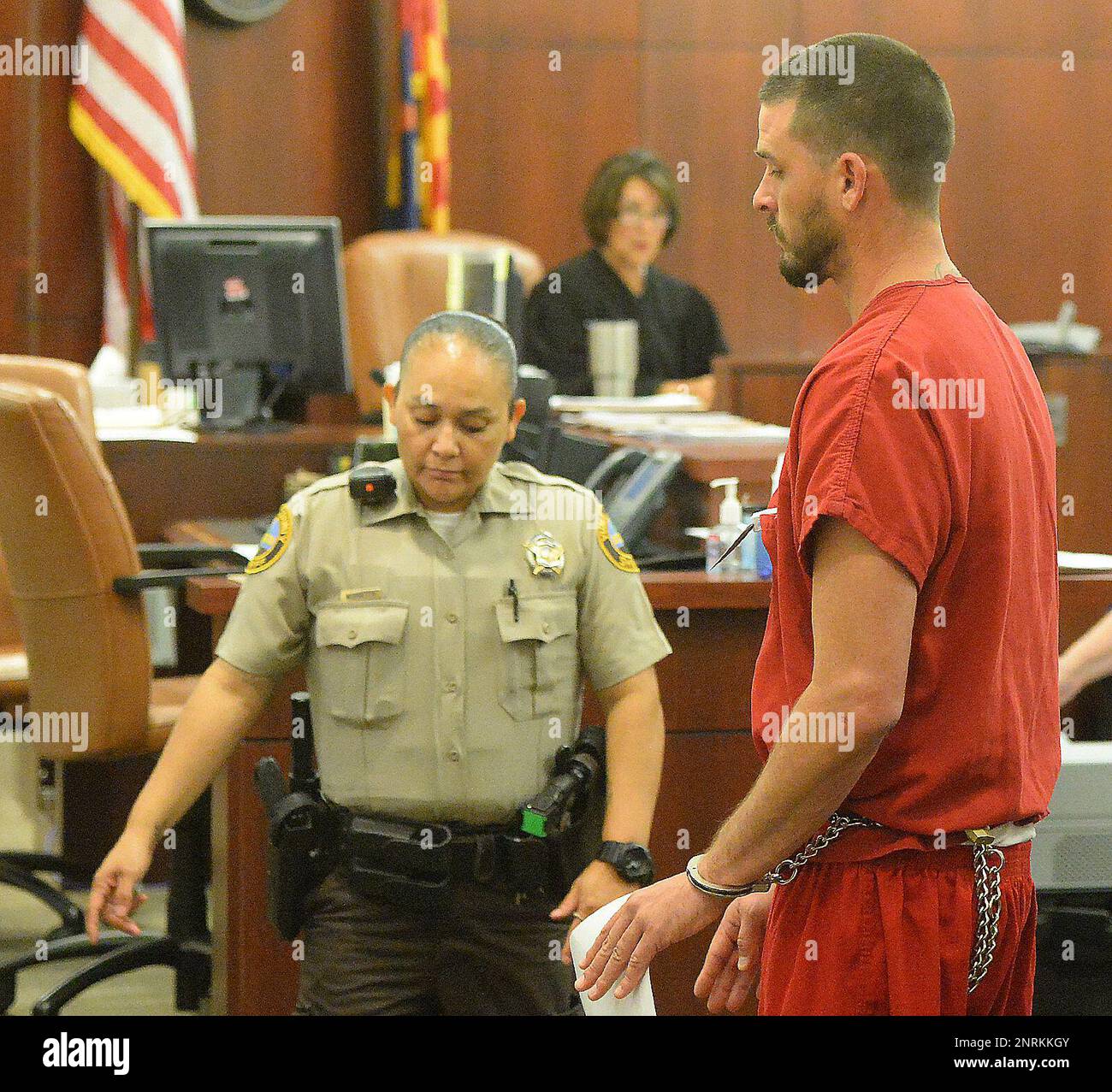 A Yuma County Sheriff's Office Adult Detention Center officer (left) shows Benjamin Griffith the ...