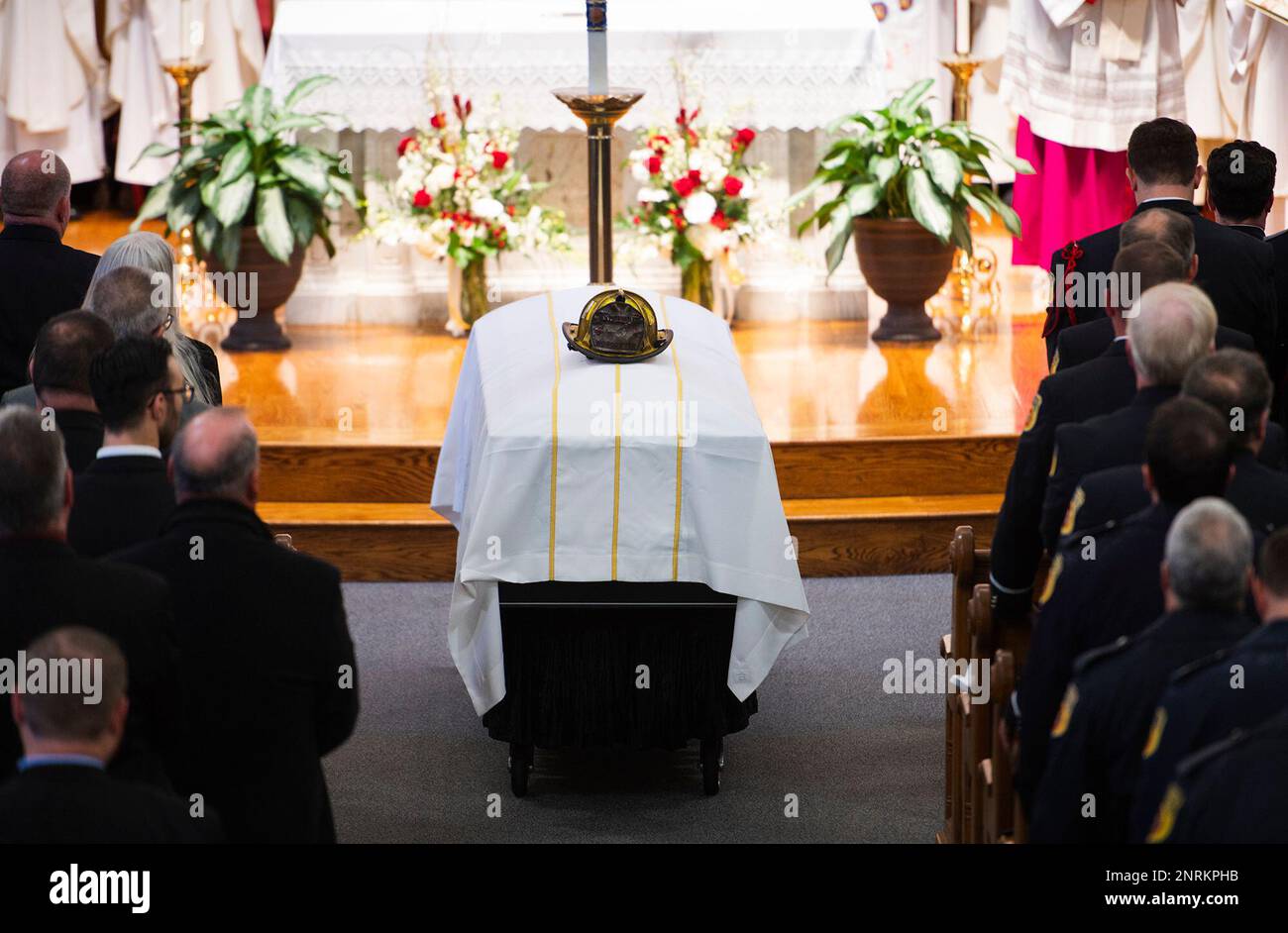 The helmet of Worcester Fire Lt. Jason Menard rests on his casket ...
