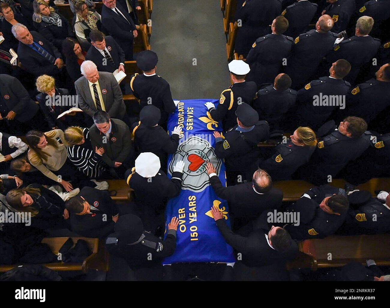 Pall bearers carry the casket of Worcester firefighter Lt. Jason Menard ...