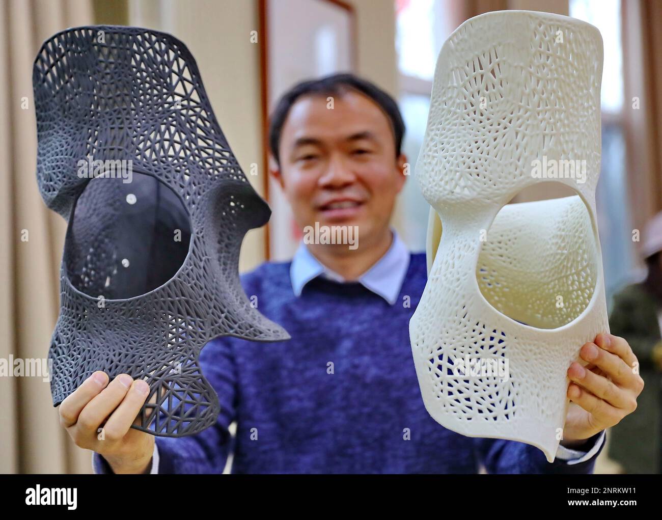 An exhibitor shows the 3D-printed spinal orthoses during a design ...