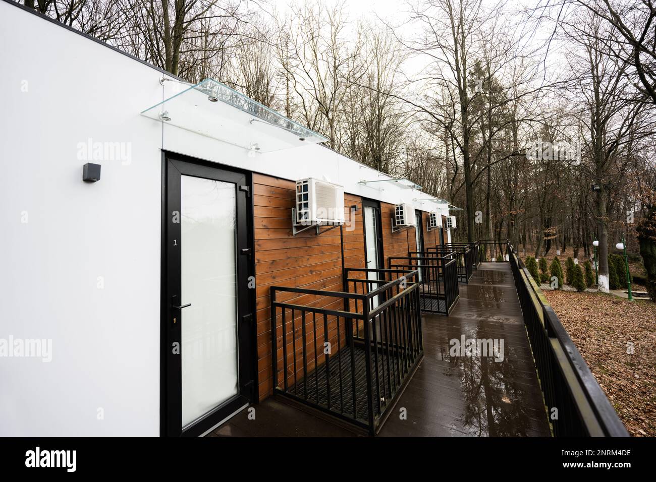 Terrace of one-storey modular houses in spring rainy forest Stock Photo ...