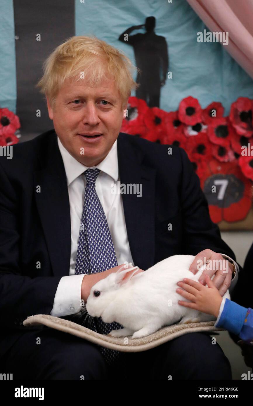 Britain's Prime Minister Boris Johnson hold Rosie the rabbit during a ...