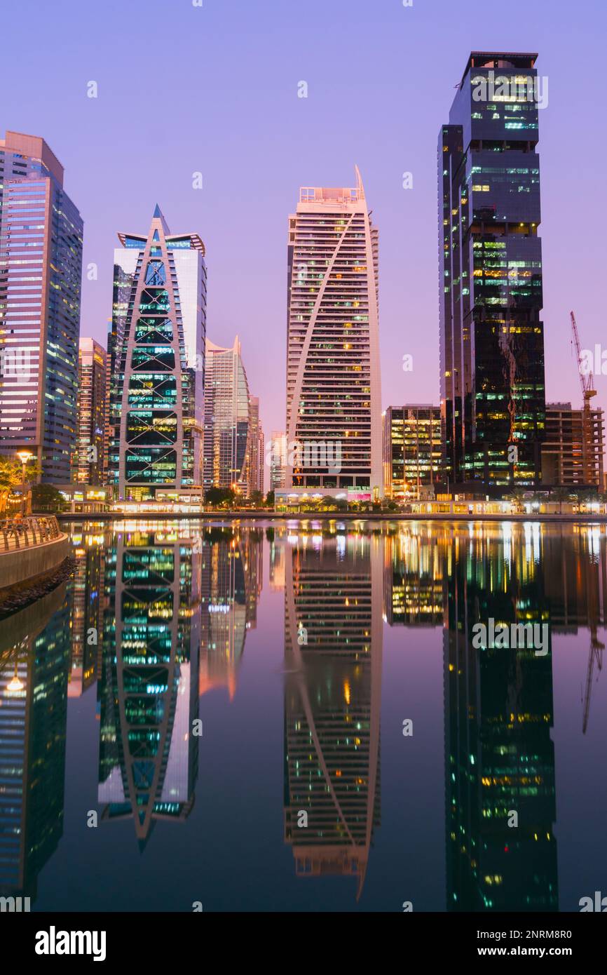 Modern skyscrapers and water pier of Dubai Marina at sunset and blue ...