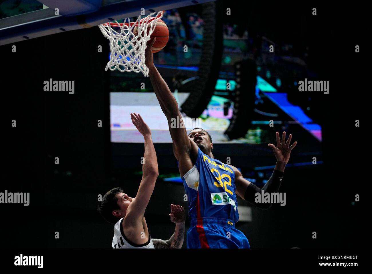 Philippines' Justin Brownlee, right, drives past Jordan's Sami Bzai ...