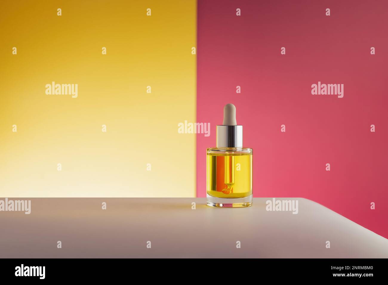 yellow face and hair oil in glass bottles with pipette dropper on ...