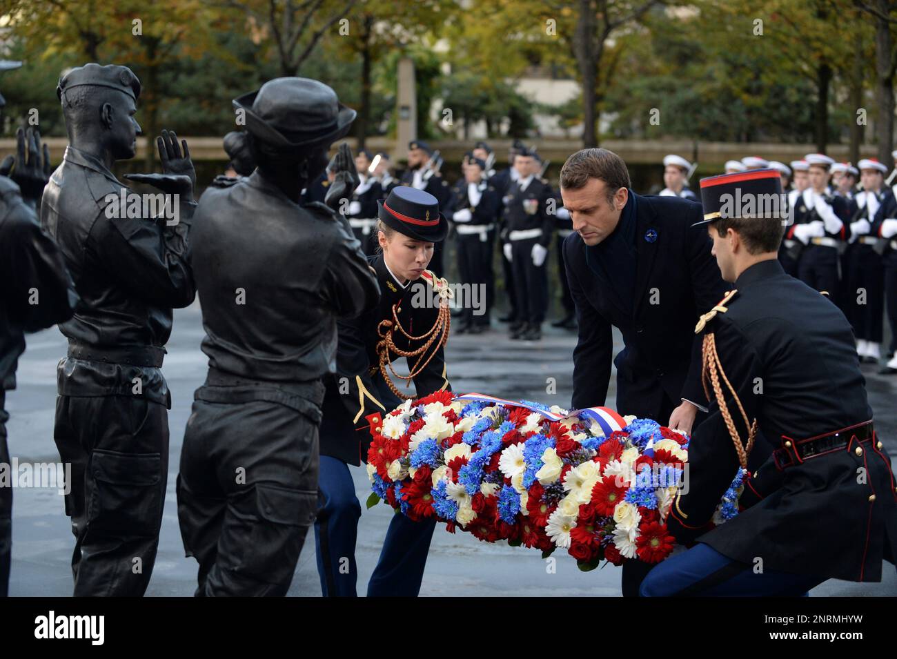 French President Emmanuel Macron lays a wreath of flowers as he ...