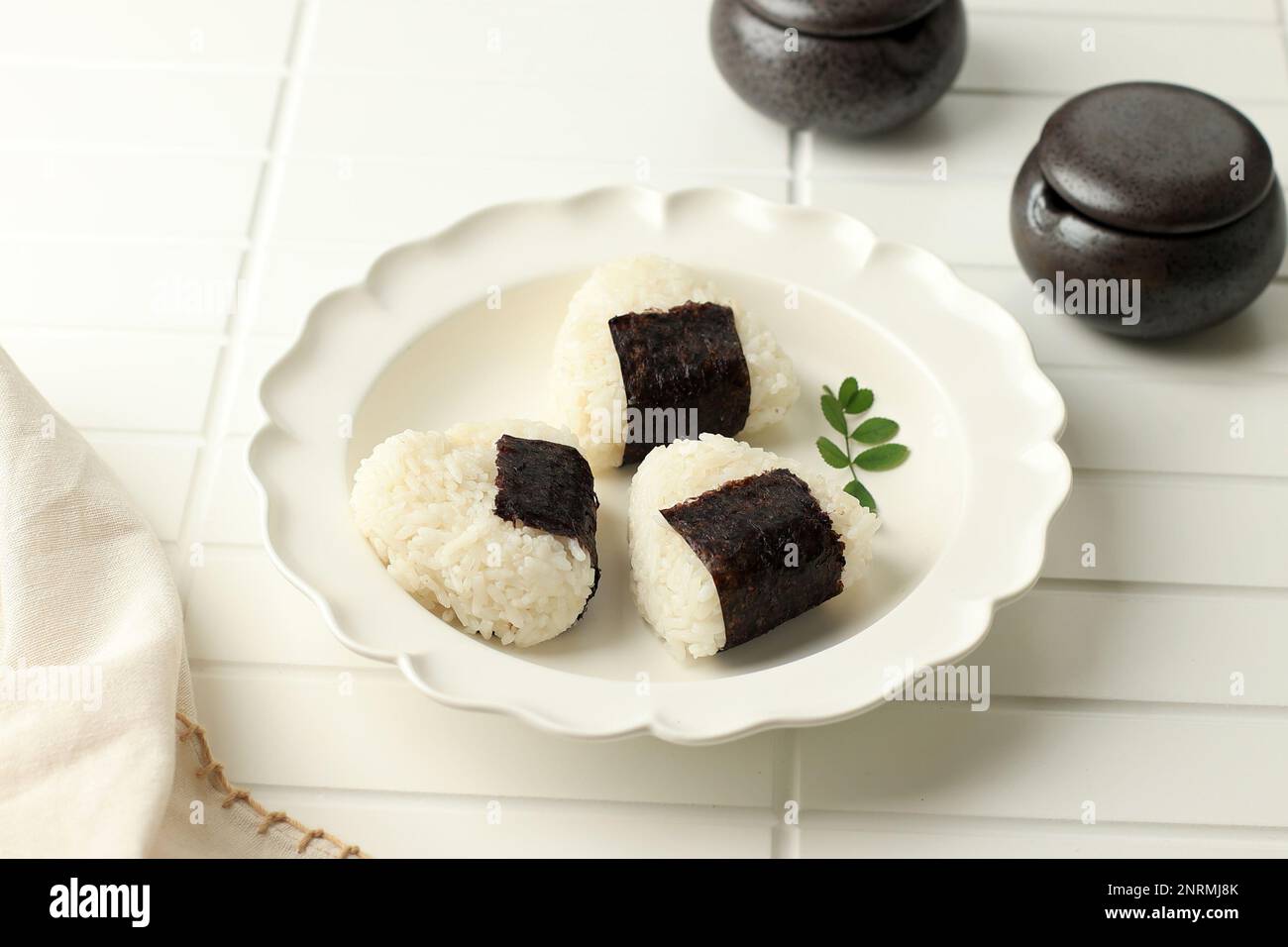 Onigiri. Japanese Rice Triangle with Nori Seaweed on White Plate Stock ...