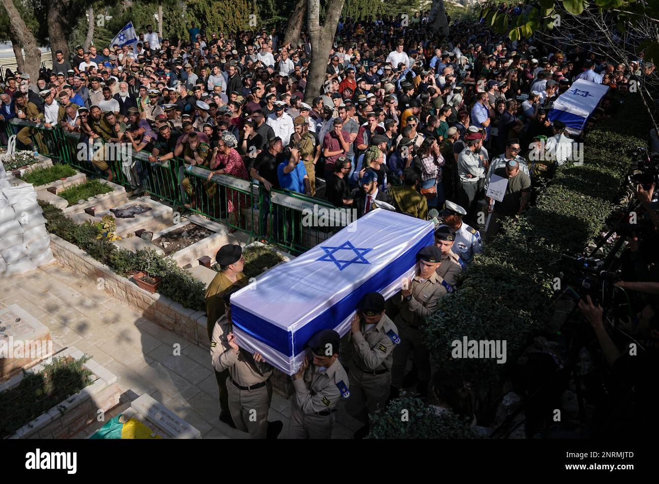 Israeli soldiers and mourners carry the flag-draped coffins of Hillel ...