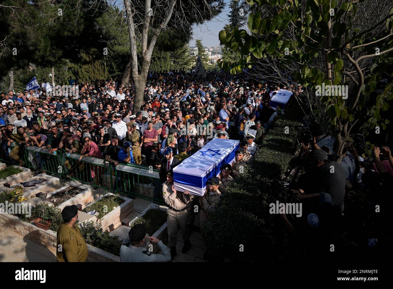 Israeli soldiers and mourners carry the flag-draped coffins of Hillel ...