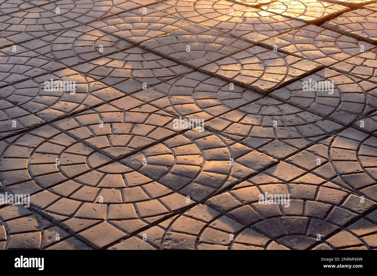 Paving slabs incorrectly lie in waves in the sun on a street in the ...
