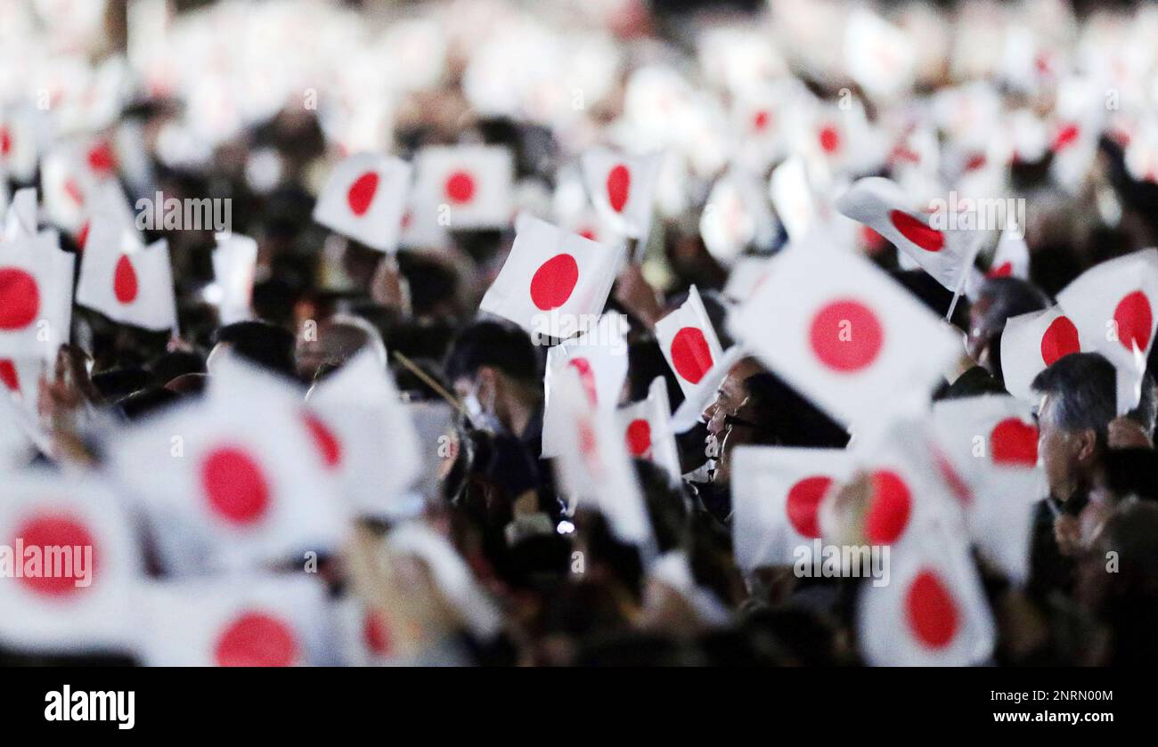 Japanese well-wishers hold national flags during the National Festival ...
