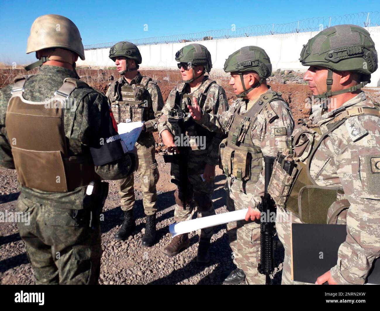 Turkish army officers, right, speak with a Russian army officer near ...