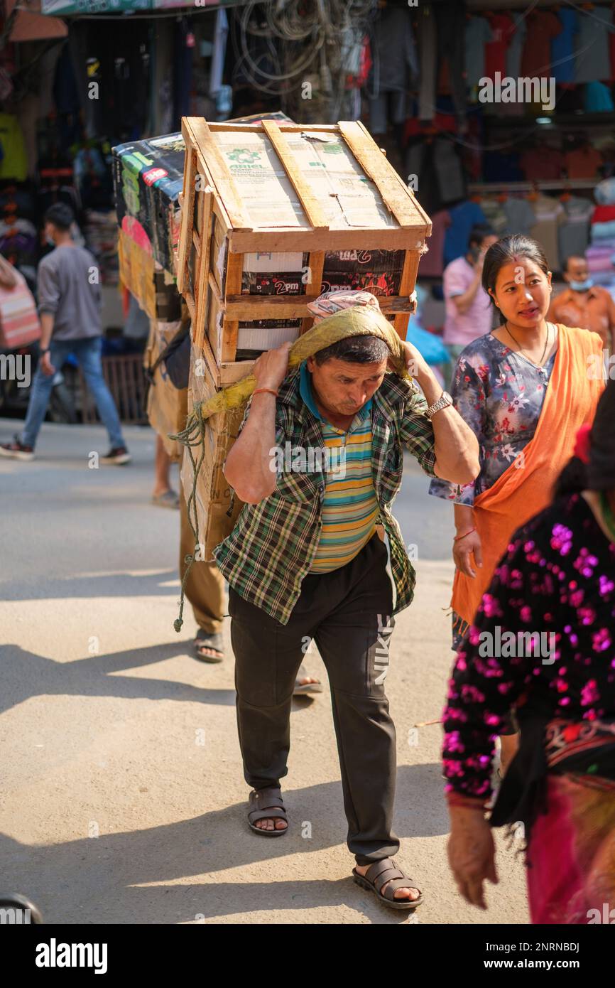 Kathmandu, Nepal, 04 23 2022: Man carrying stacked goods on his head ...